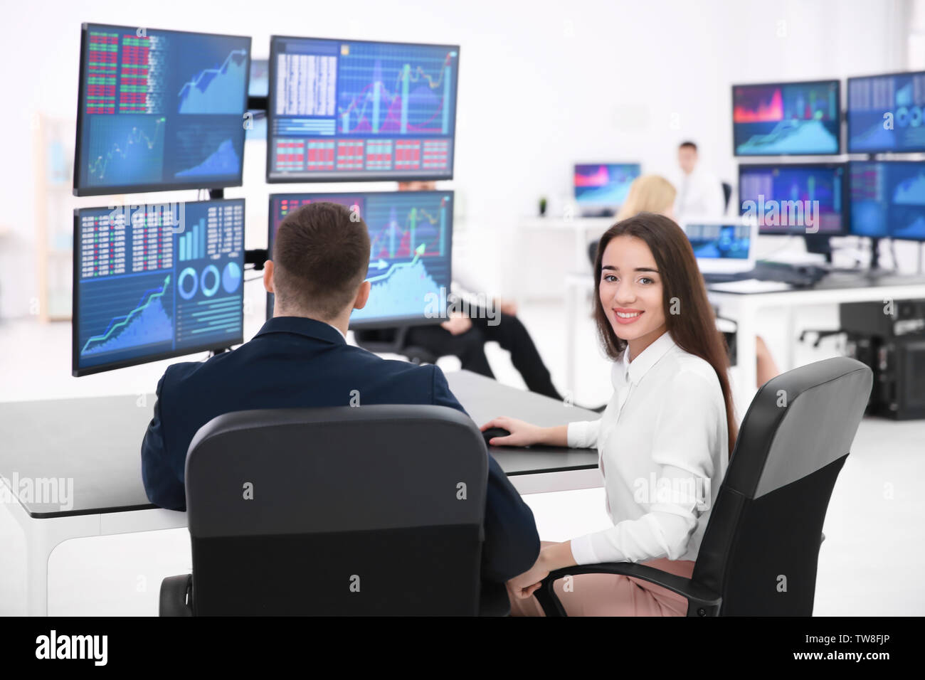 Stock traders working in office Stock Photo - Alamy