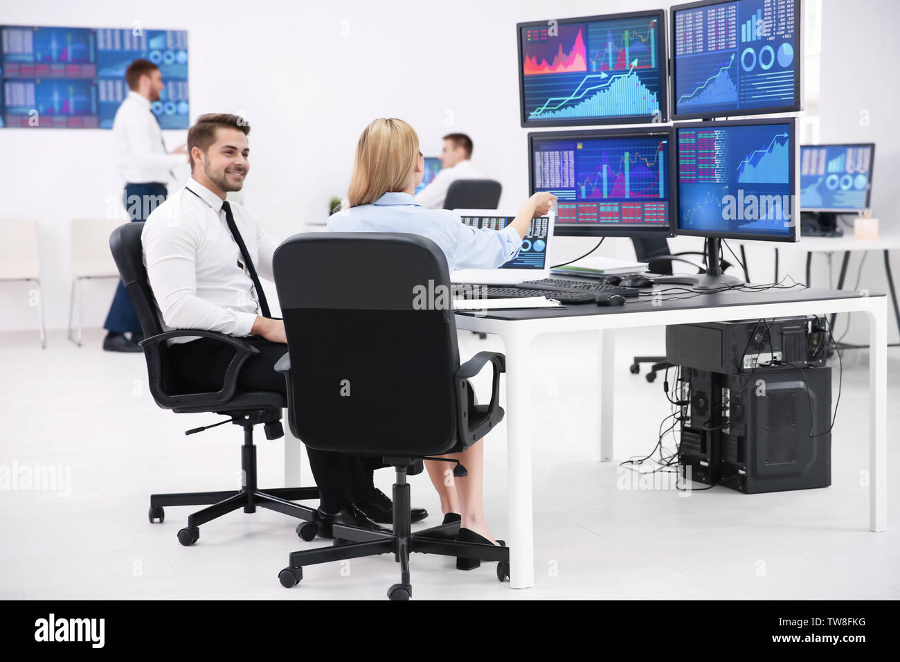 Stock traders working in office Stock Photo - Alamy