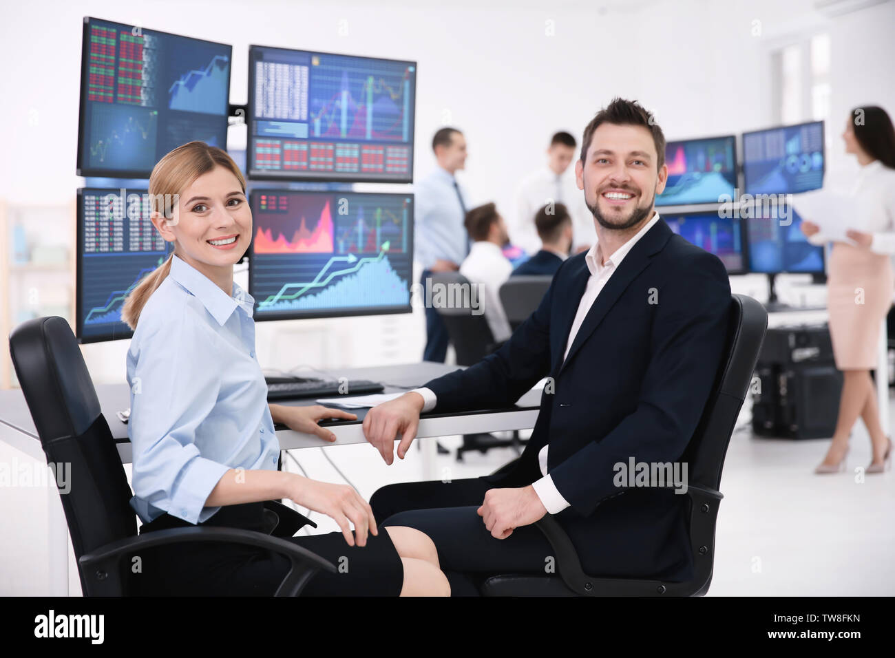 Stock traders working in office Stock Photo - Alamy