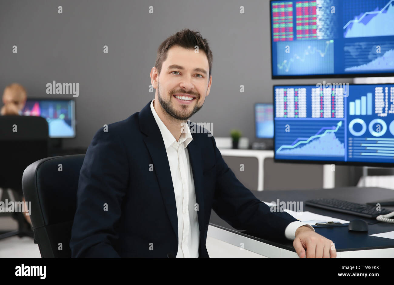 Male stock trader working in office Stock Photo - Alamy