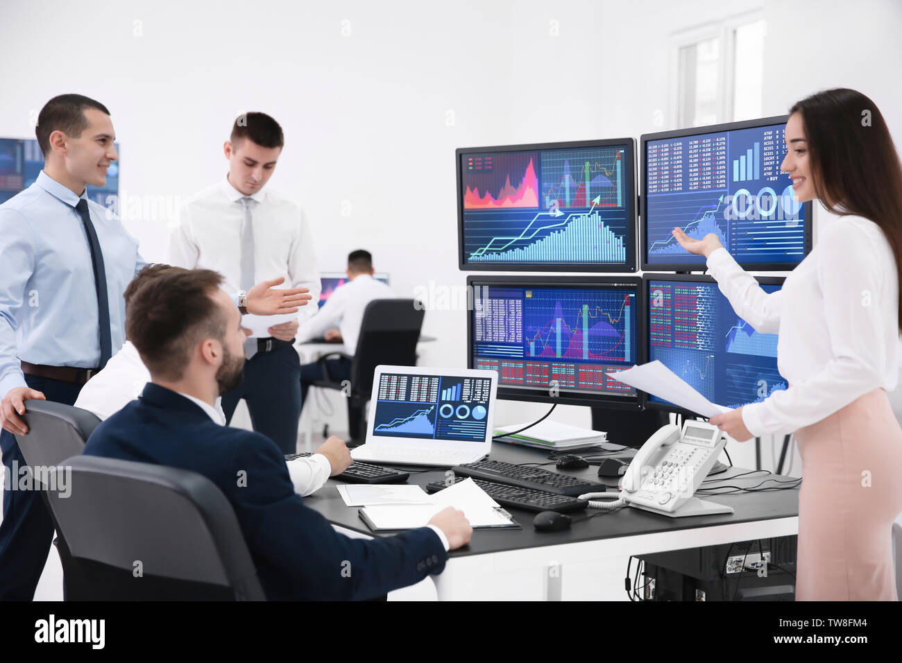 Stock traders working in office Stock Photo - Alamy