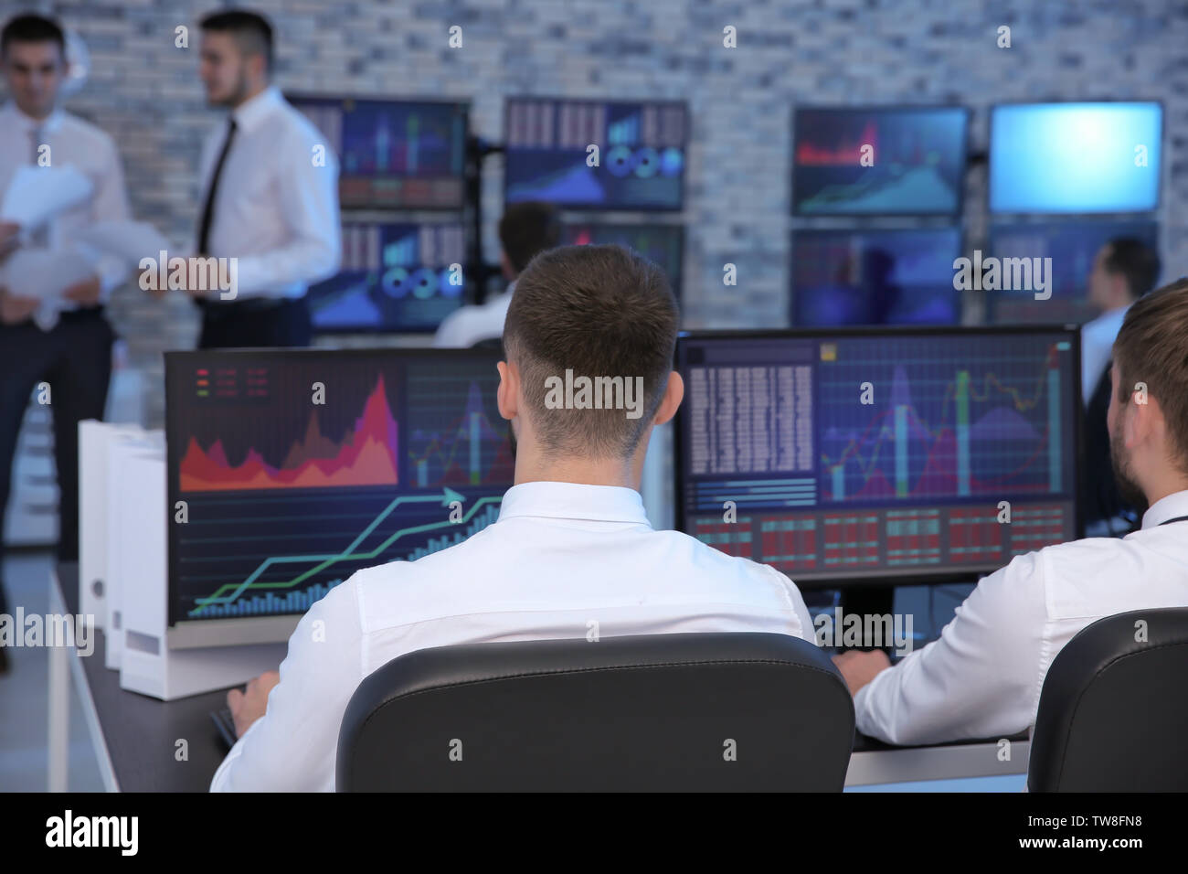 Stock traders working in office Stock Photo - Alamy