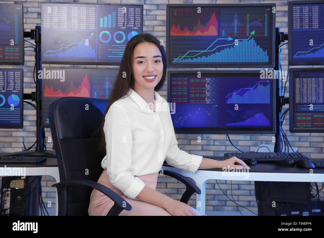 Female stock trader working in office Stock Photo - Alamy