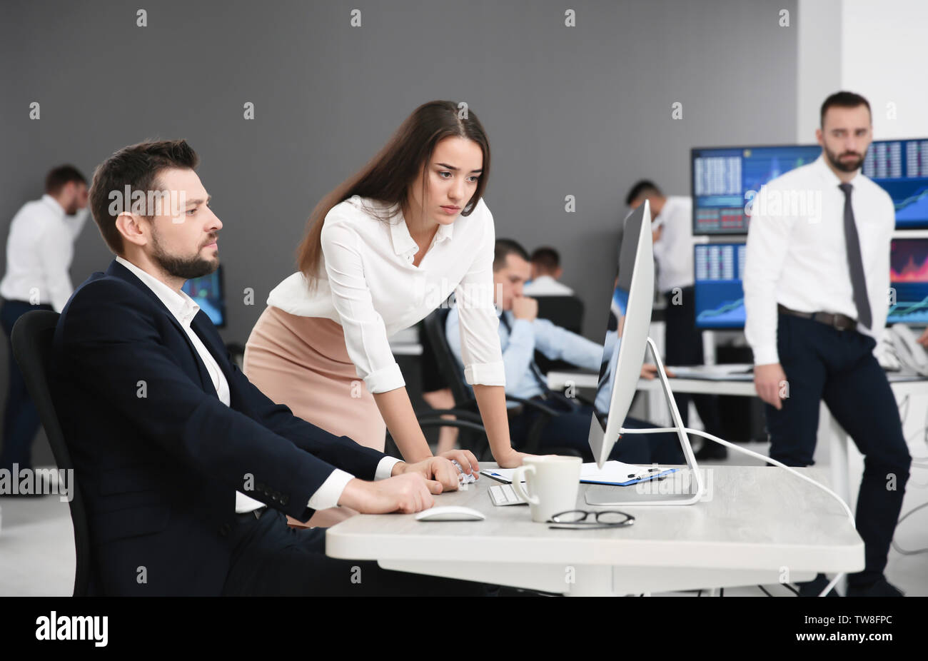 Stock traders working in office Stock Photo - Alamy