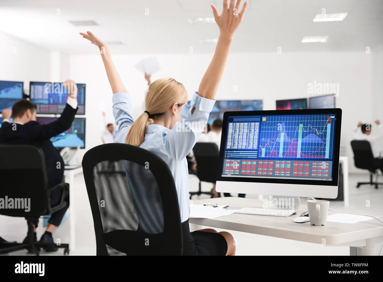 Female stock trader working in office Stock Photo - Alamy