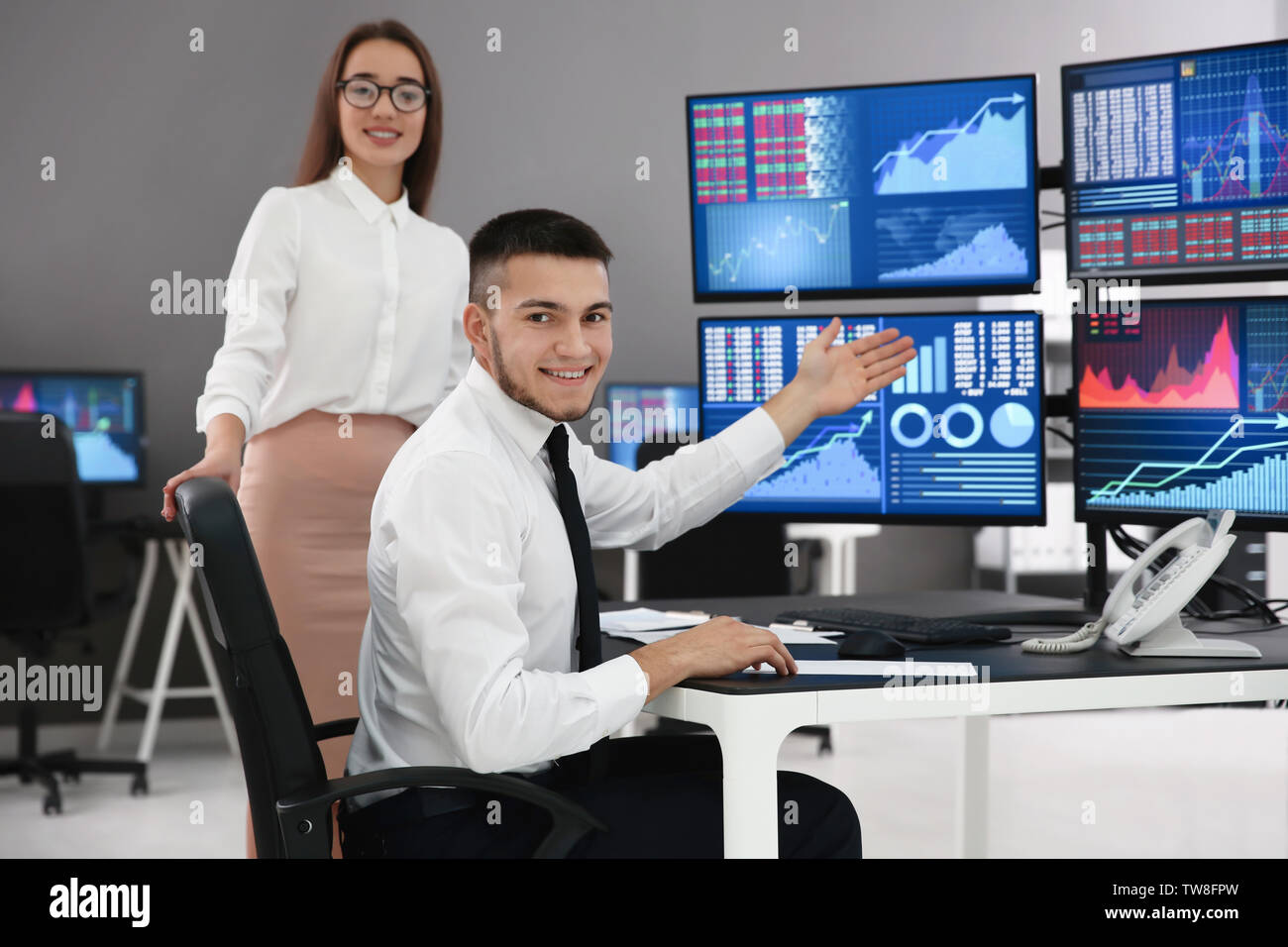 Stock traders working in office Stock Photo - Alamy