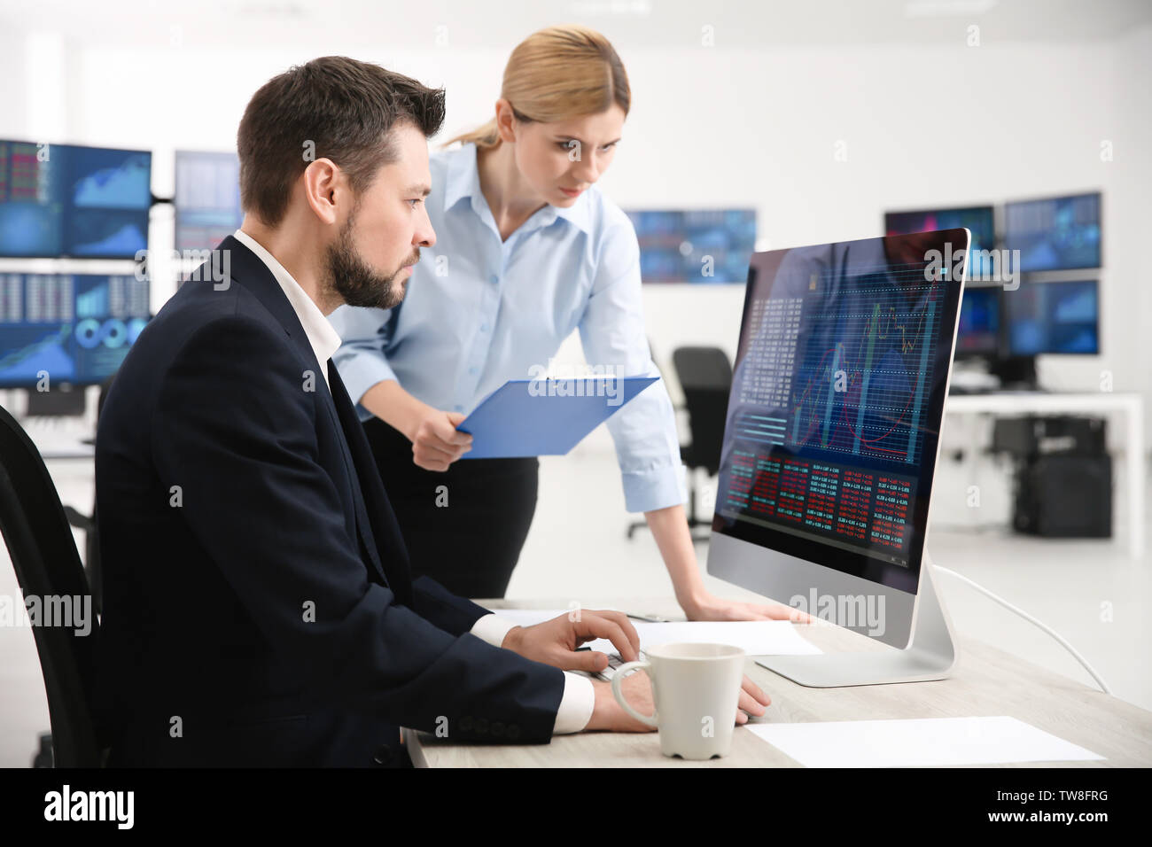 Stock traders working in office Stock Photo - Alamy