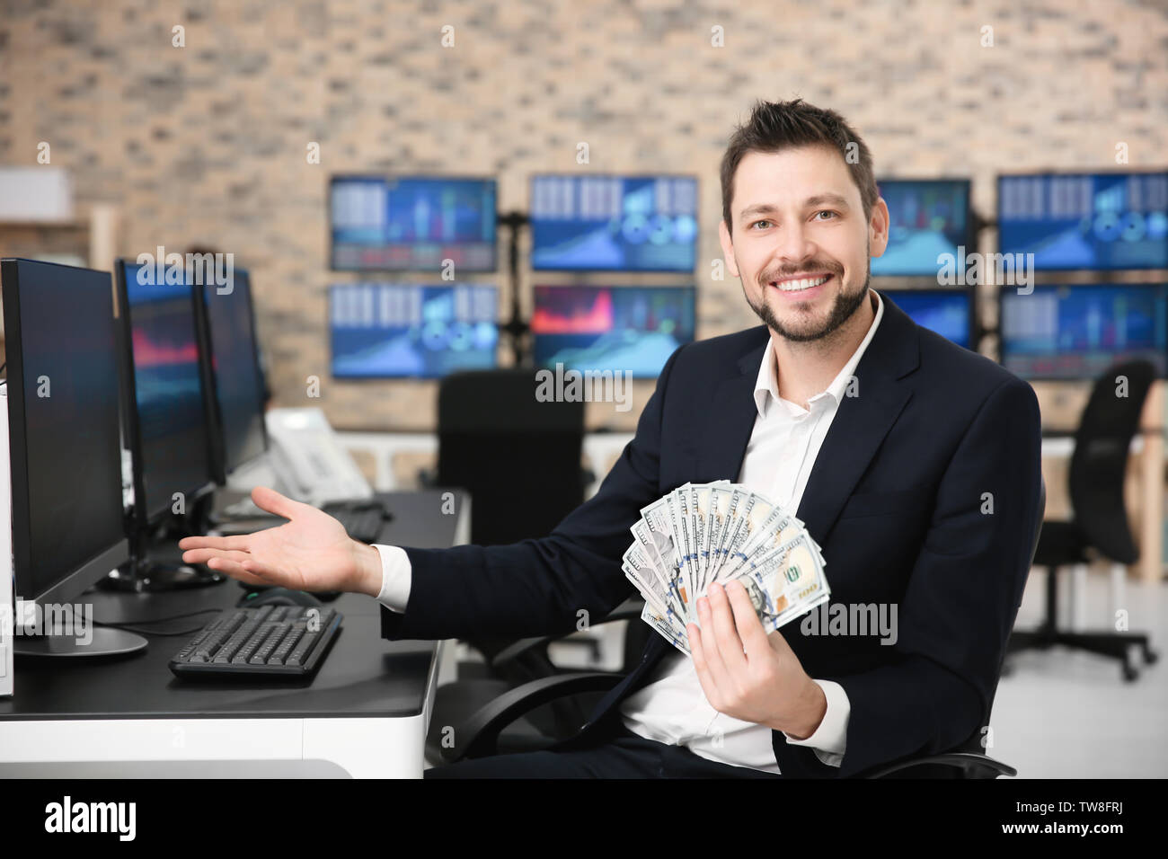 Male stock trader working in office Stock Photo - Alamy
