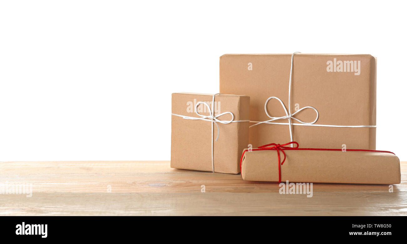 Parcel gift boxes on table against white background Stock Photo - Alamy