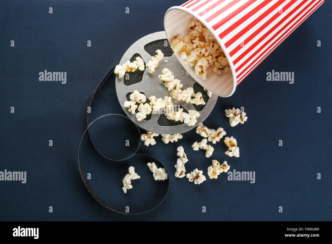Composition with popcorn and cinema film on dark background Stock Photo ...