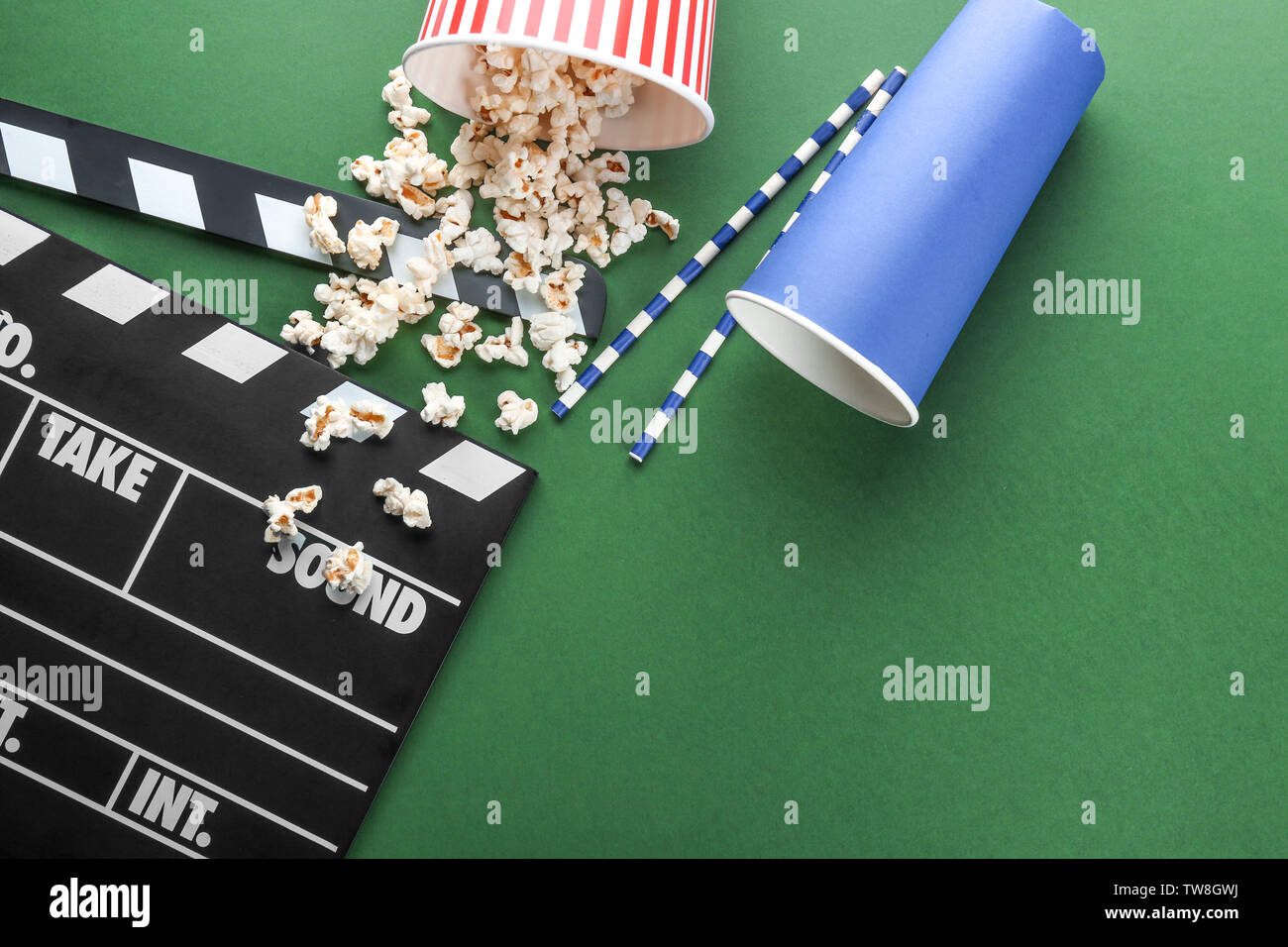 Composition with popcorn and movie clapper on color background Stock ...