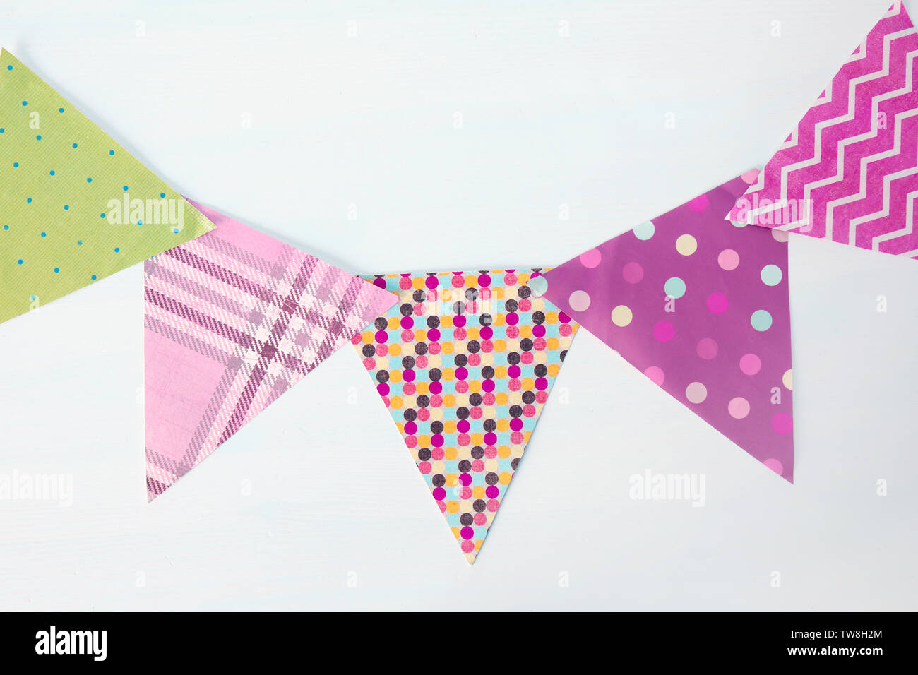 Handmade colorful garland on light background Stock Photo - Alamy