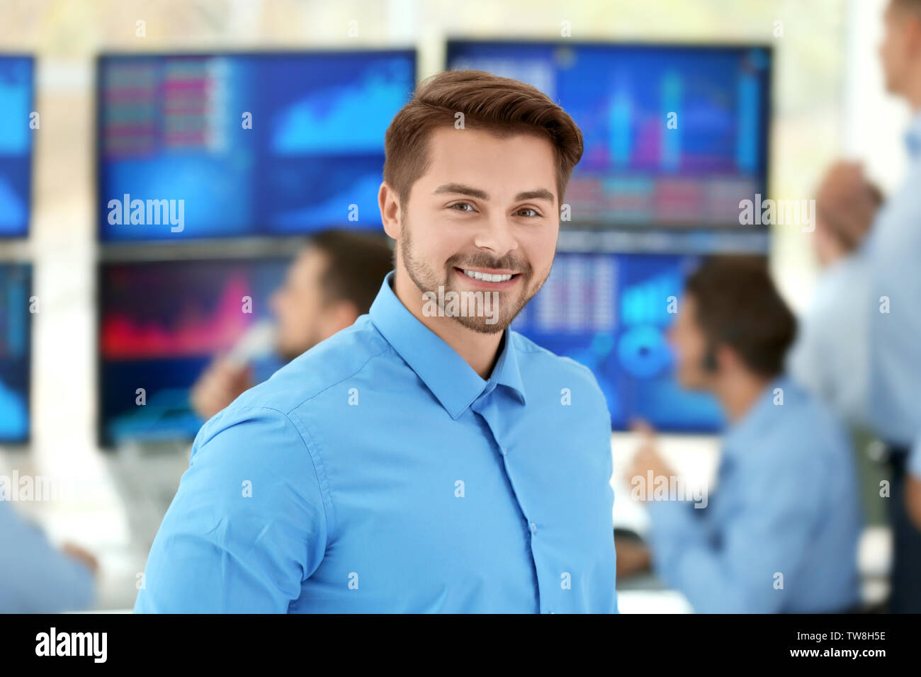 Happy male stock trader in office Stock Photo - Alamy