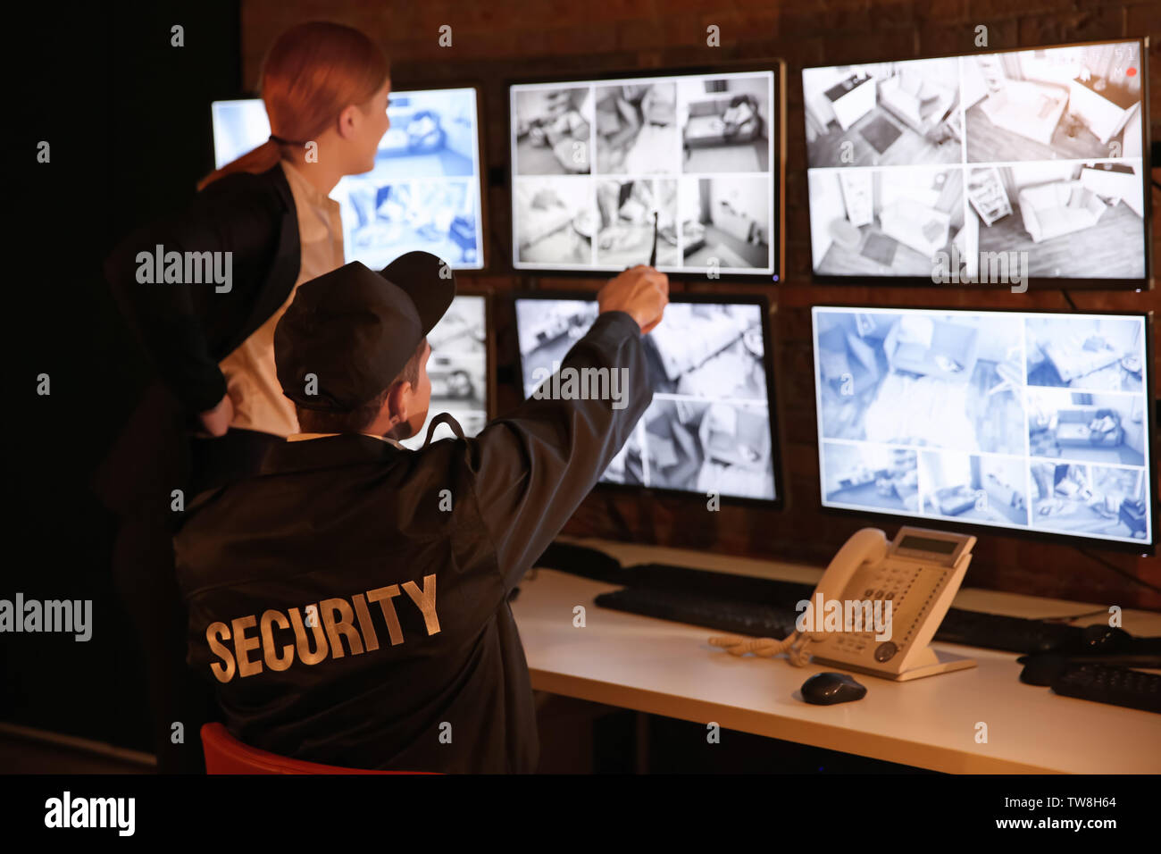 Security guards working in surveillance room Stock Photo - Alamy
