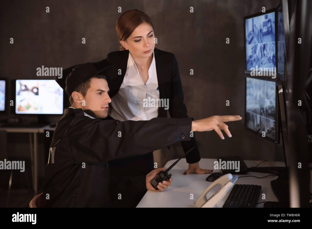 Security guards working in surveillance room Stock Photo - Alamy