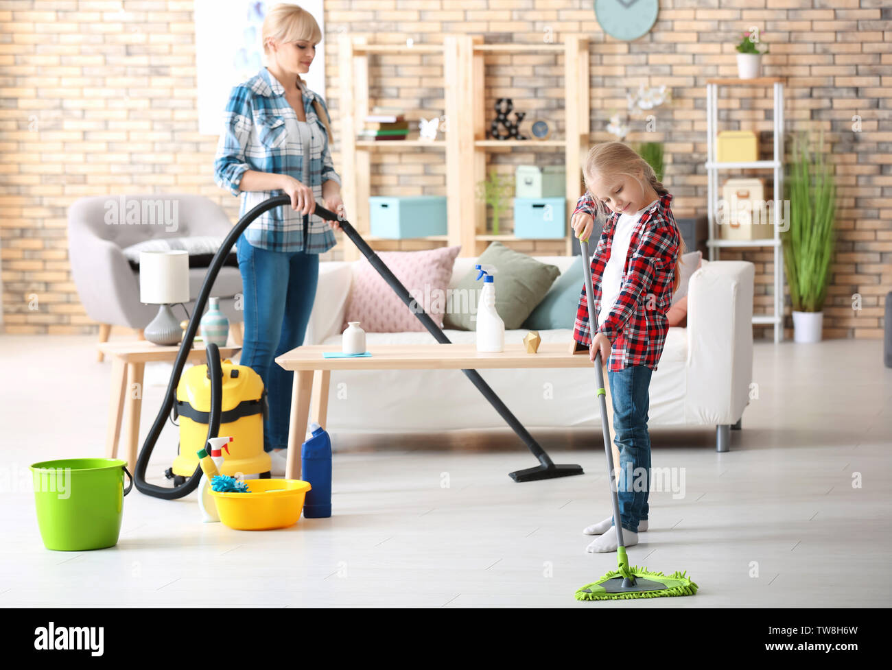 Little girl and her mother cleaning floor at home Stock Photo - Alamy