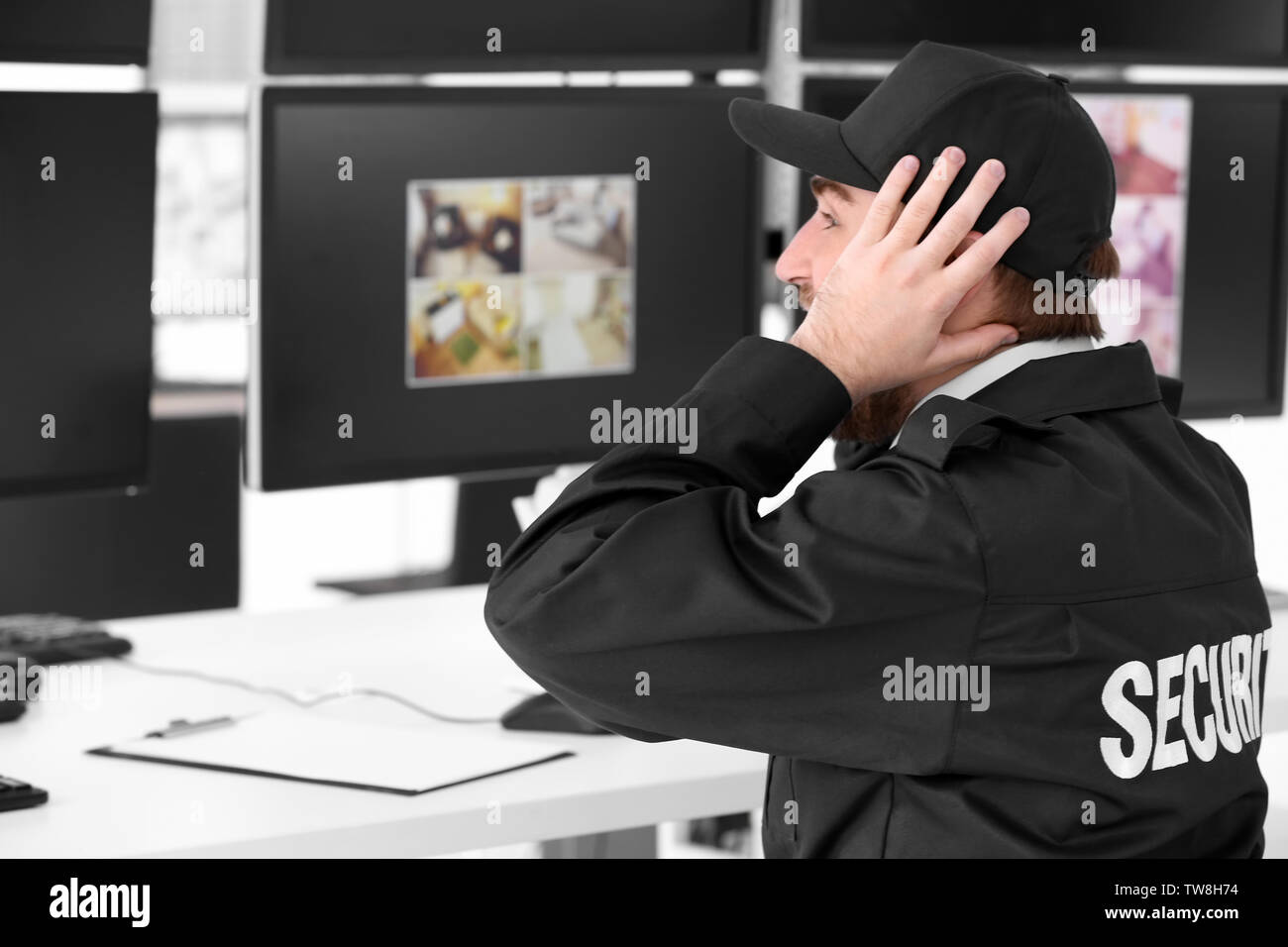 Shocked security guard in surveillance room Stock Photo - Alamy