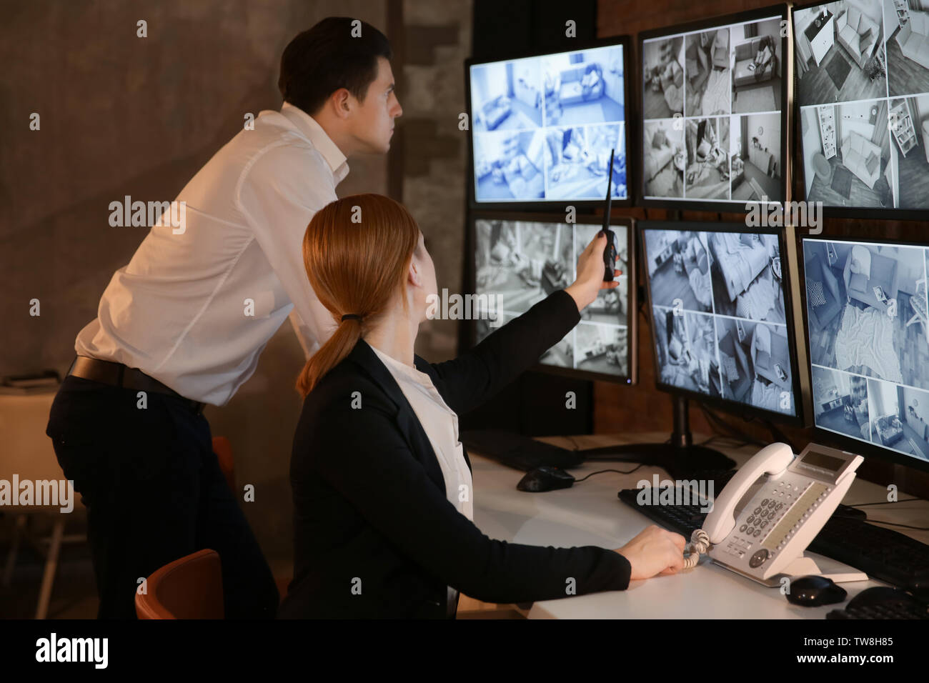 Security guards working in surveillance room Stock Photo - Alamy