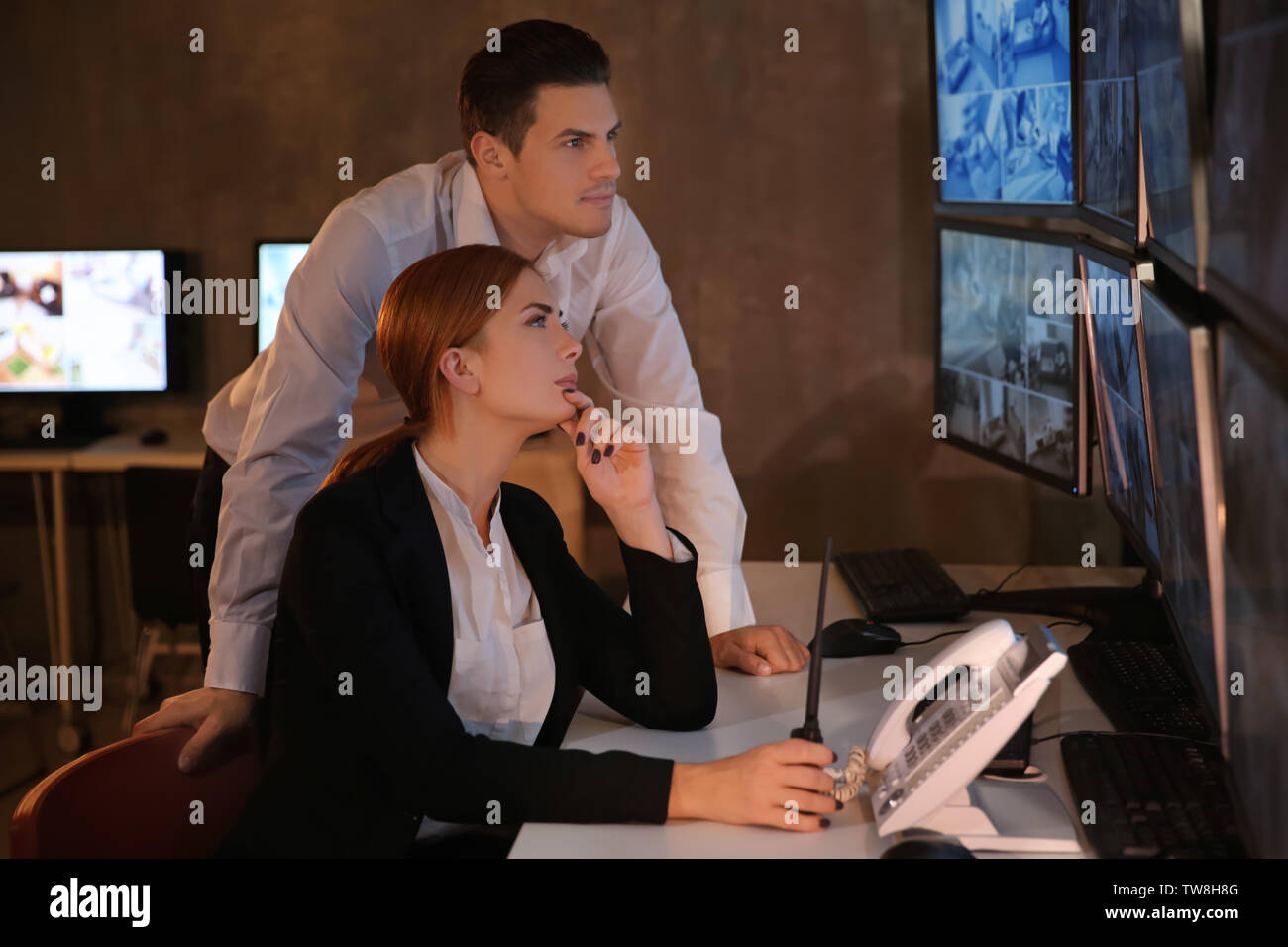 Security guards working in surveillance room Stock Photo - Alamy