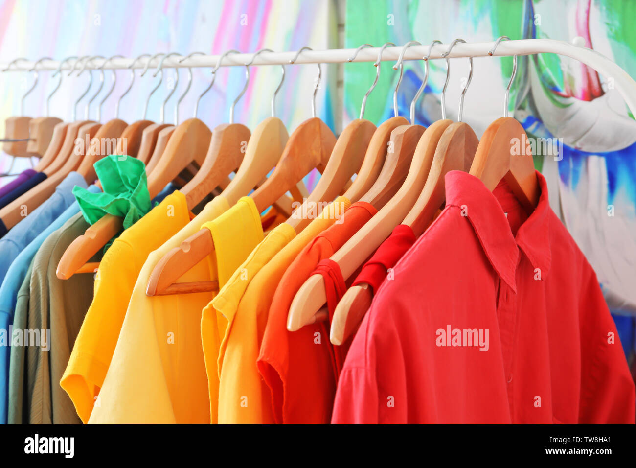 Color clothes hanging on rack Stock Photo - Alamy