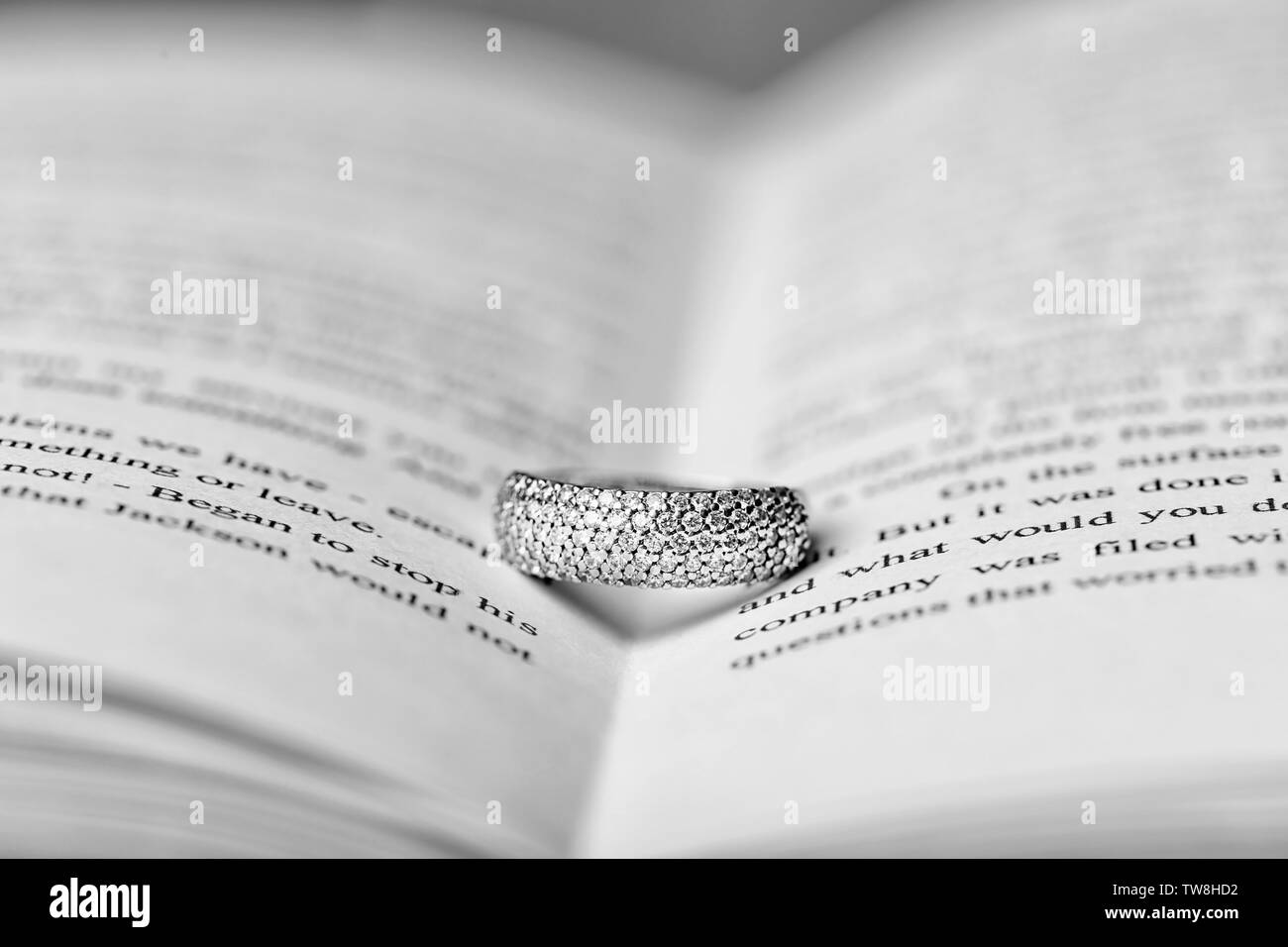 Engagement ring between pages of book, closeup Stock Photo - Alamy