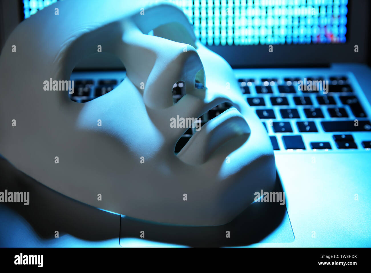 White mask on laptop keyboard, closeup Stock Photo - Alamy