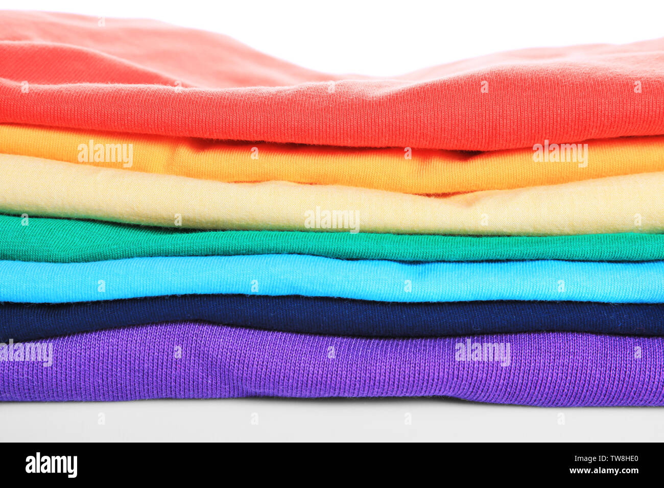 Folded rainbow clothes on white background Stock Photo - Alamy