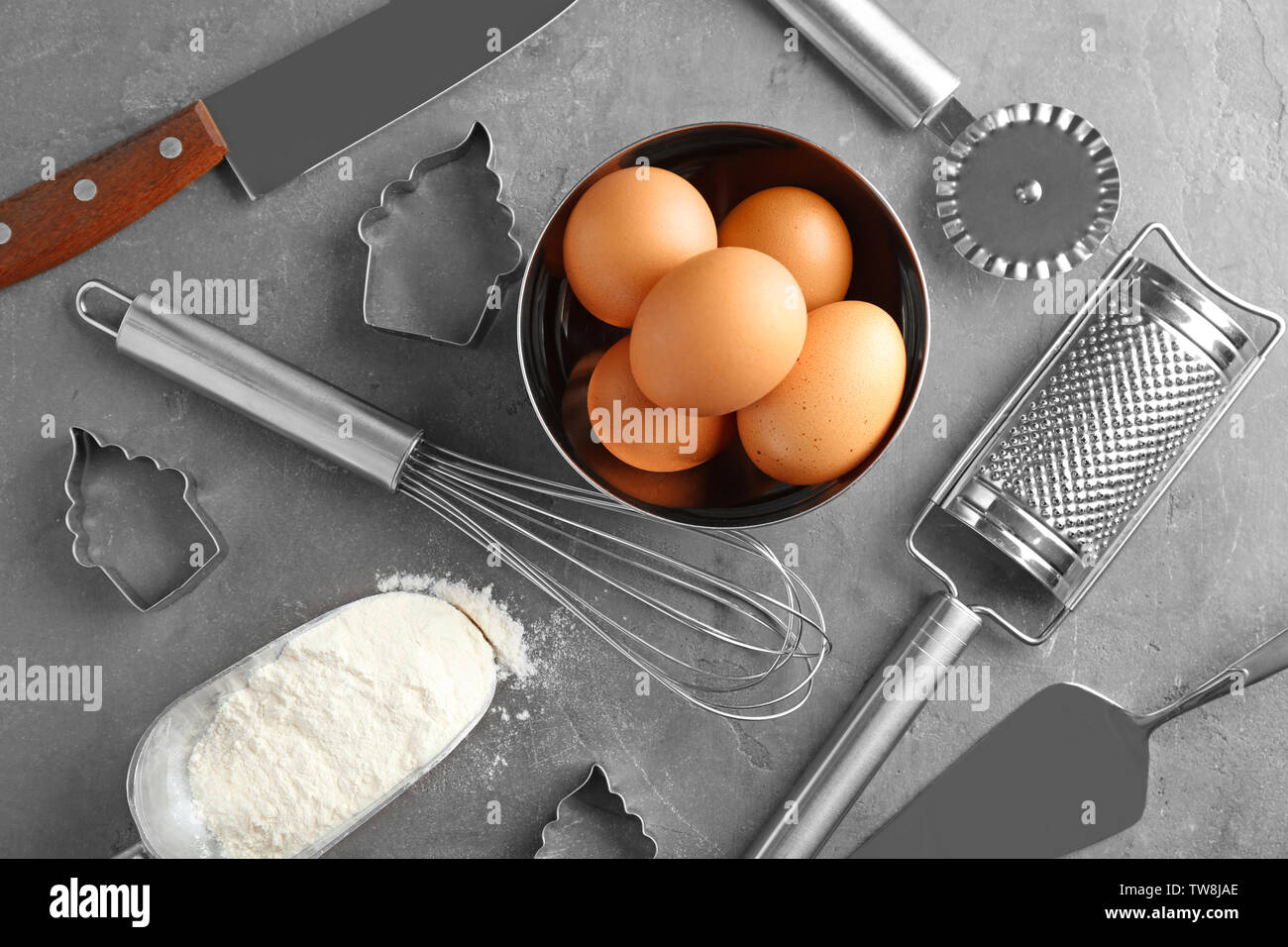 Kitchen utensils and ingredients for pastries on grey background Stock ...