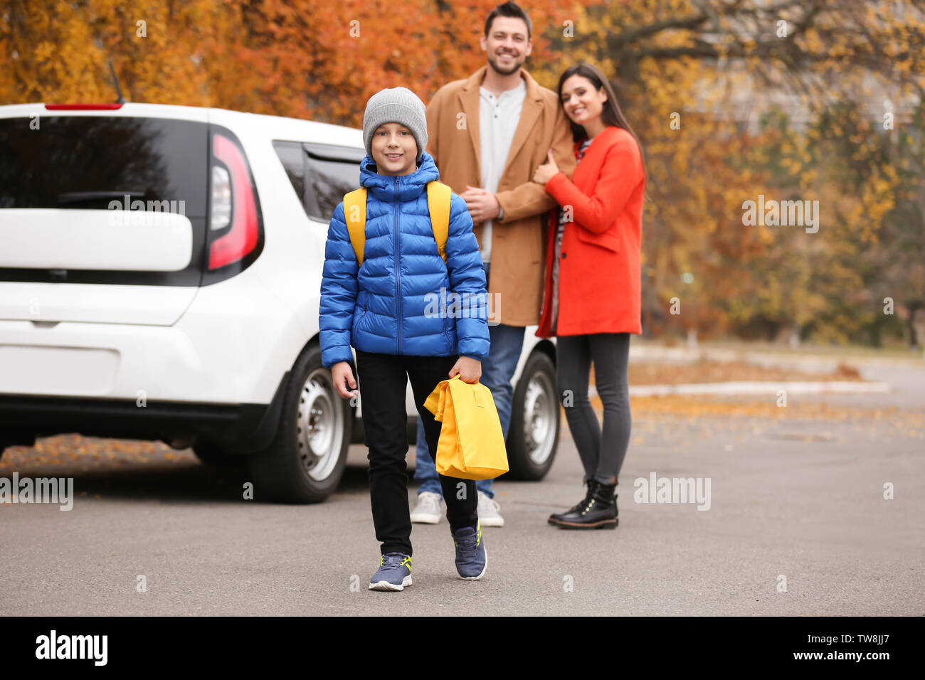 Young parents seeing their son off to school Stock Photo - Alamy