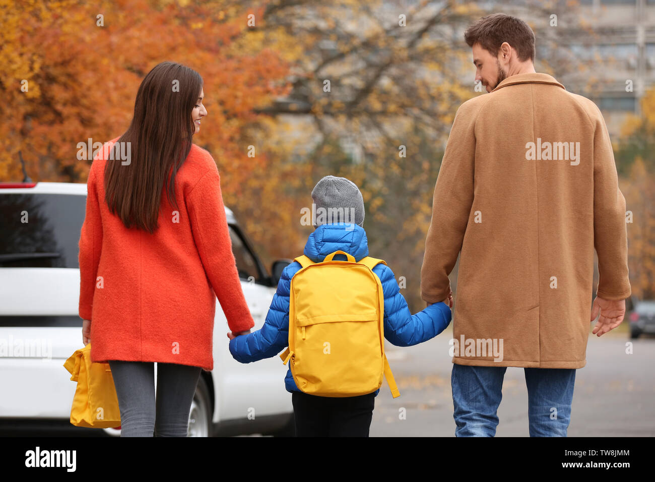 Cute little boy going to school with his parents Stock Photo - Alamy