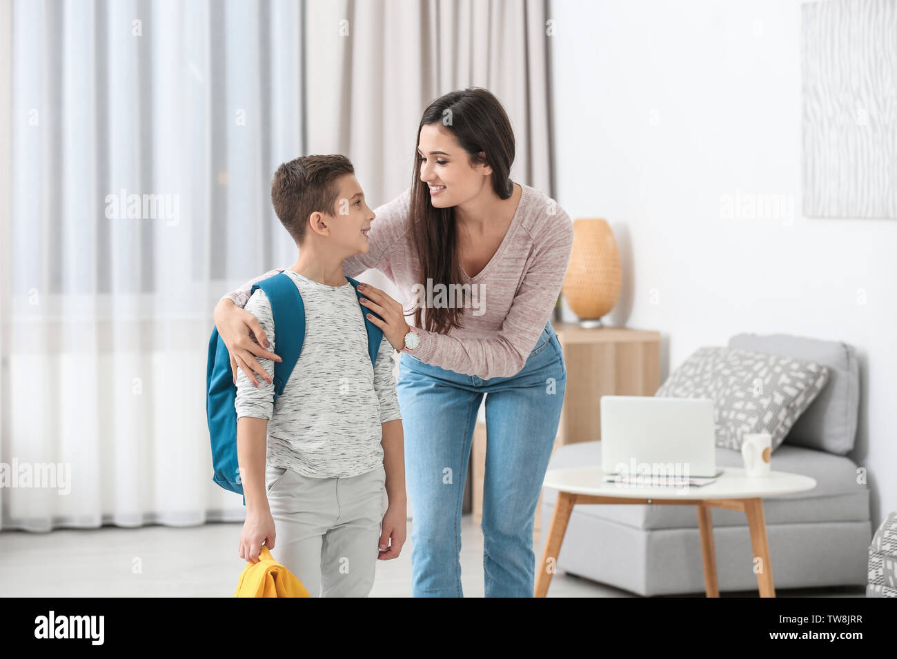 Young woman seeing her son off to school Stock Photo - Alamy