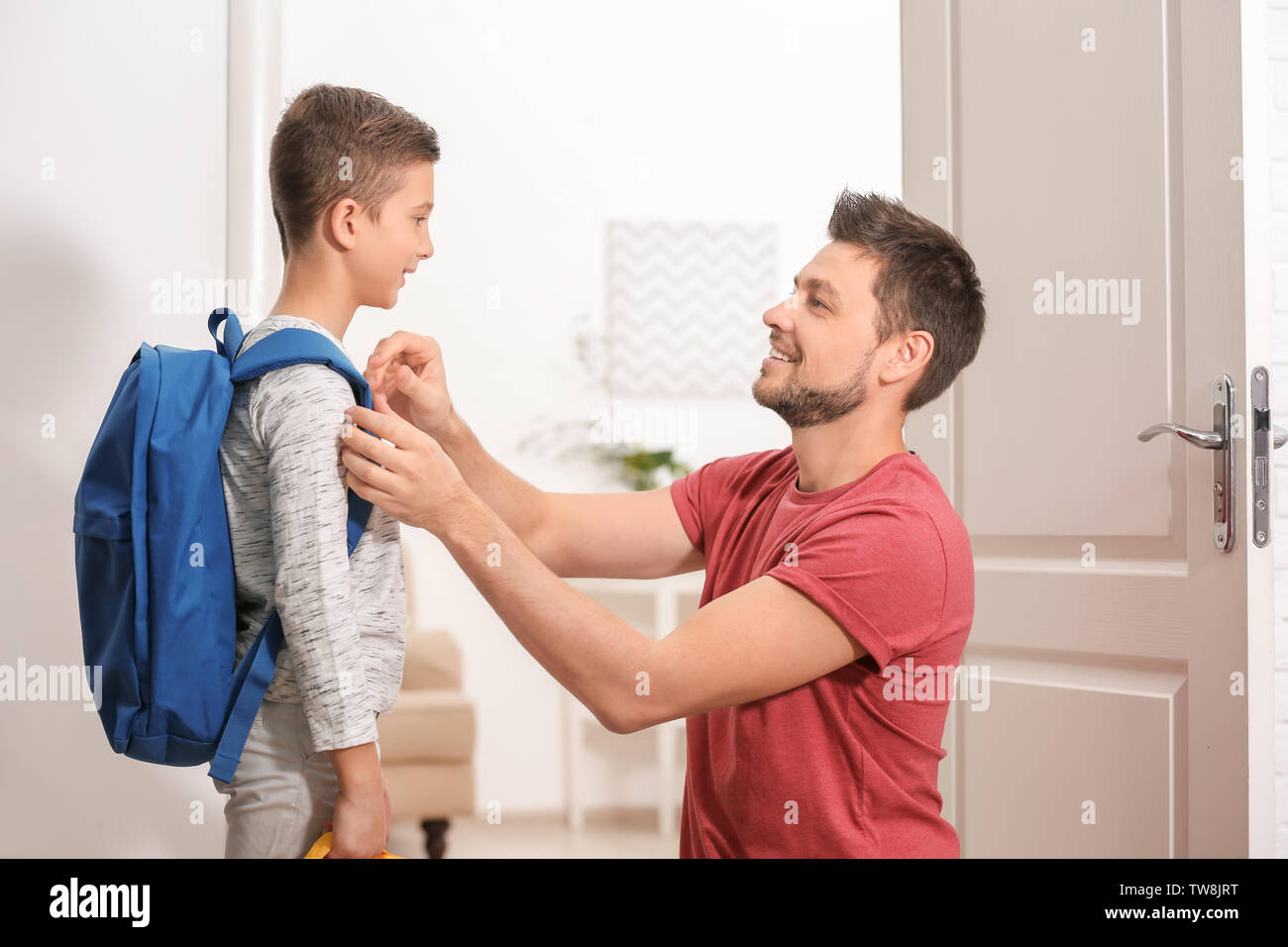 Young man saying goodbye to his son before school Stock Photo - Alamy