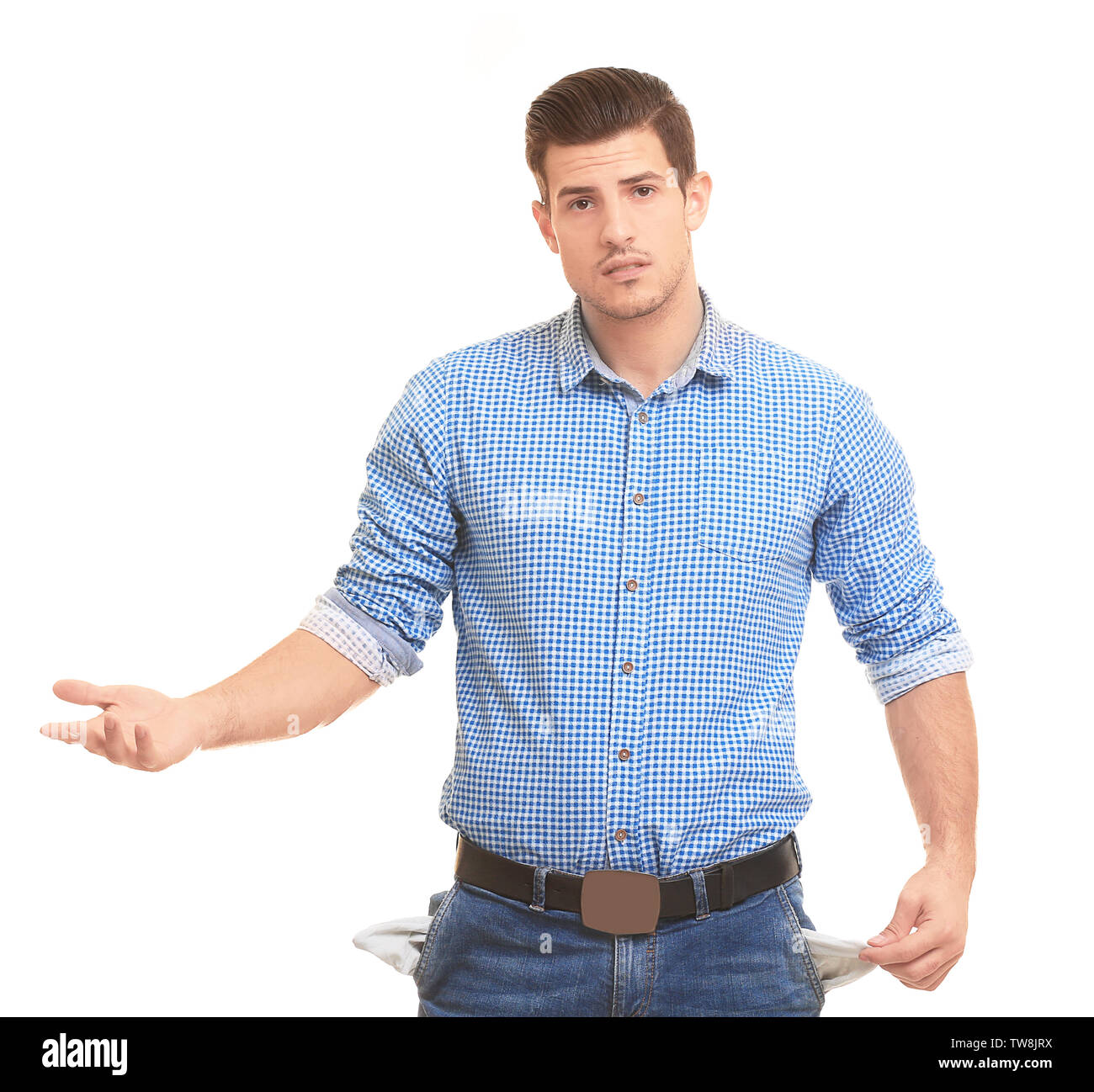 Handsome young man showing empty pockets on white background Stock ...