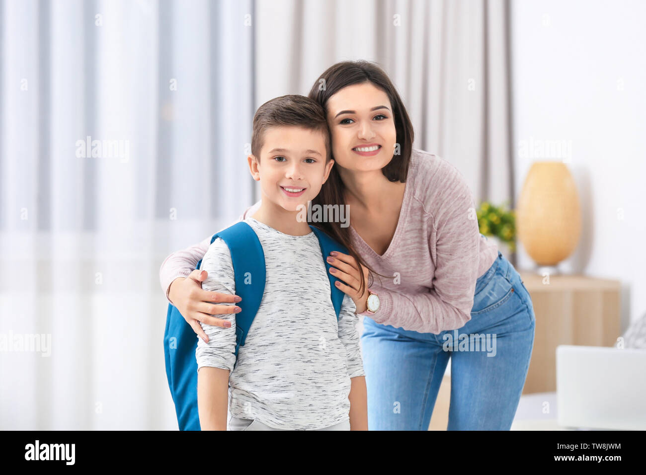 Young woman seeing her son off to school Stock Photo - Alamy