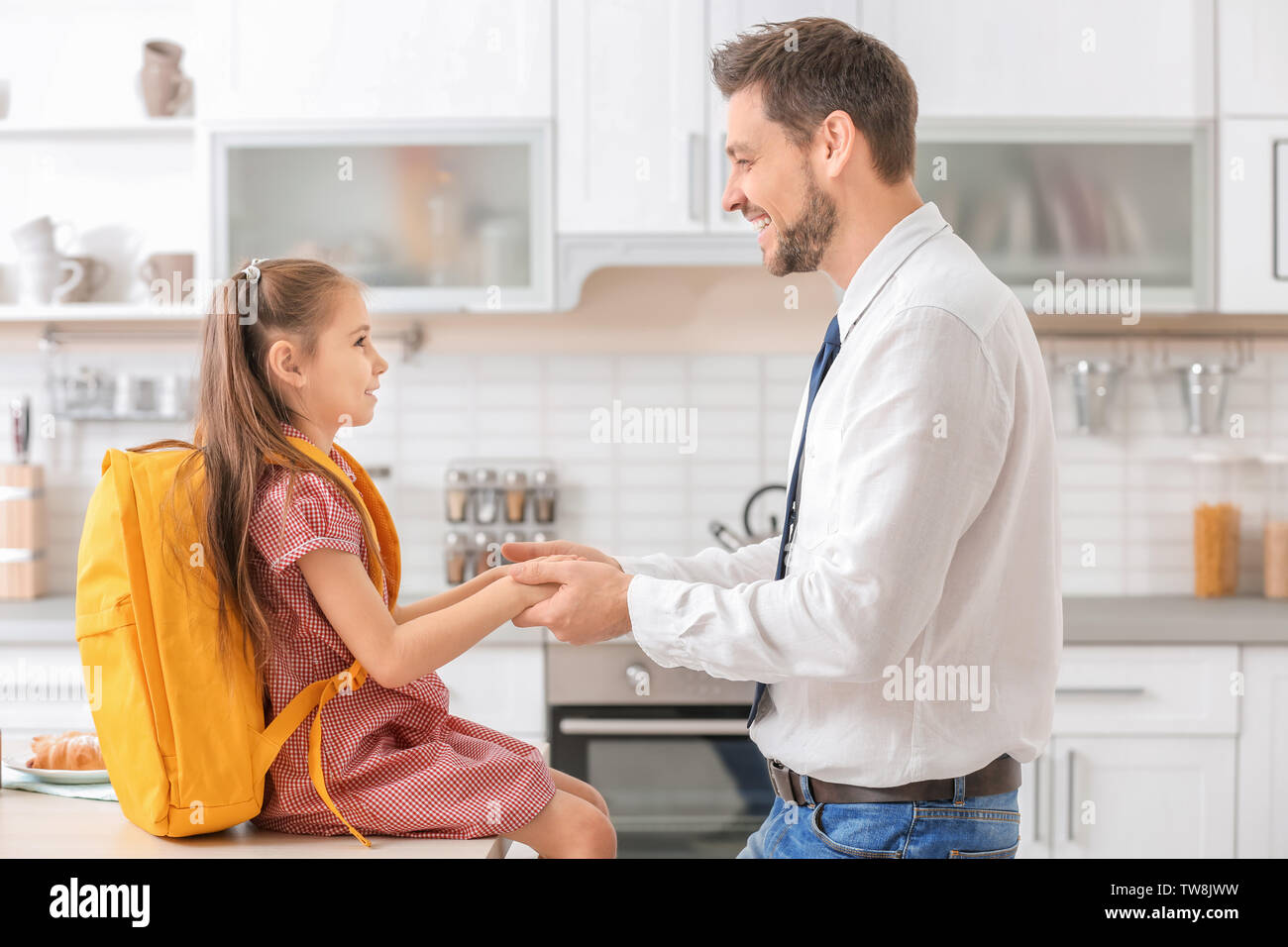 Young father helping his daughter get ready for school Stock Photo - Alamy
