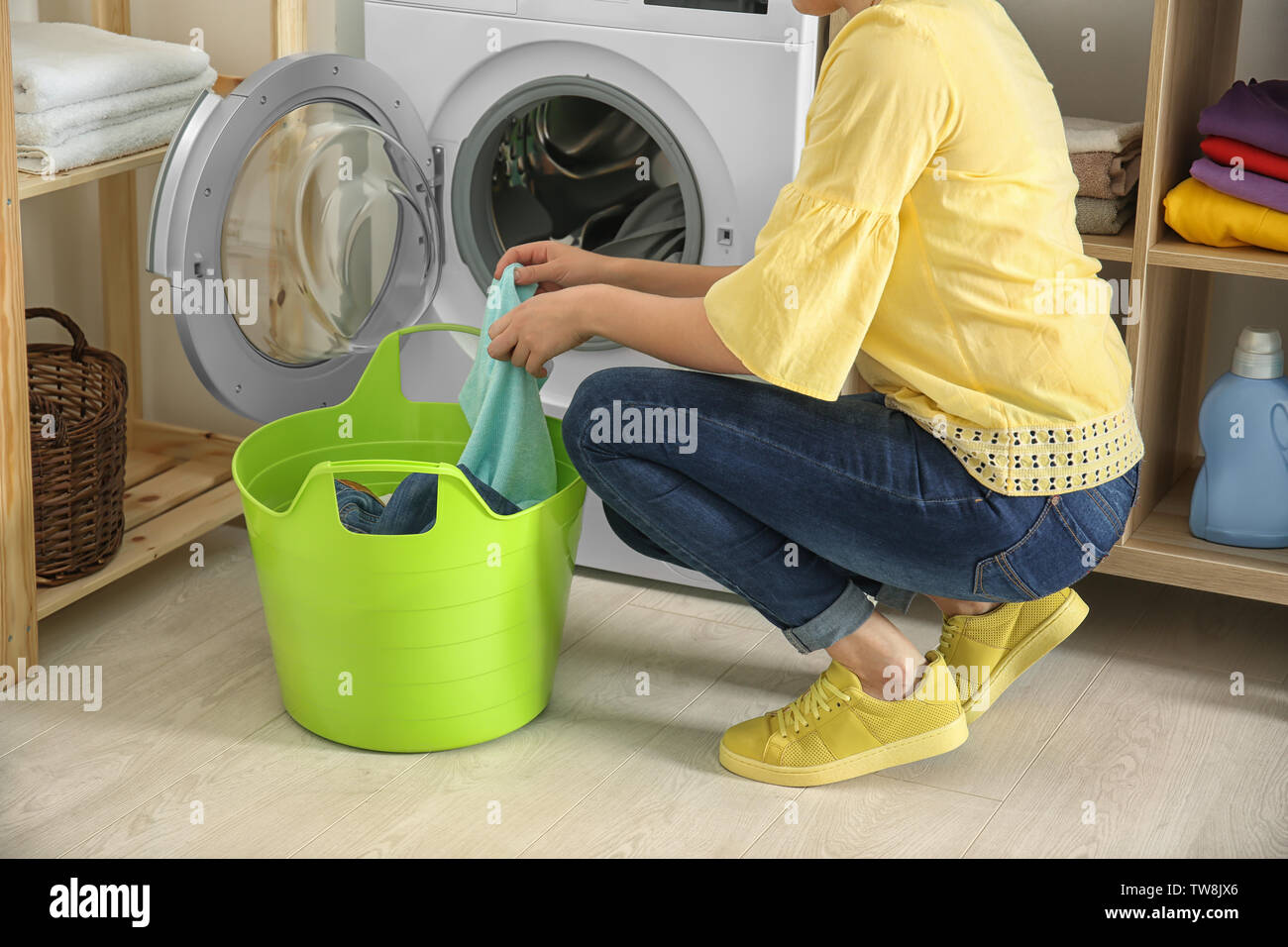 Woman doing laundry at home Stock Photo - Alamy