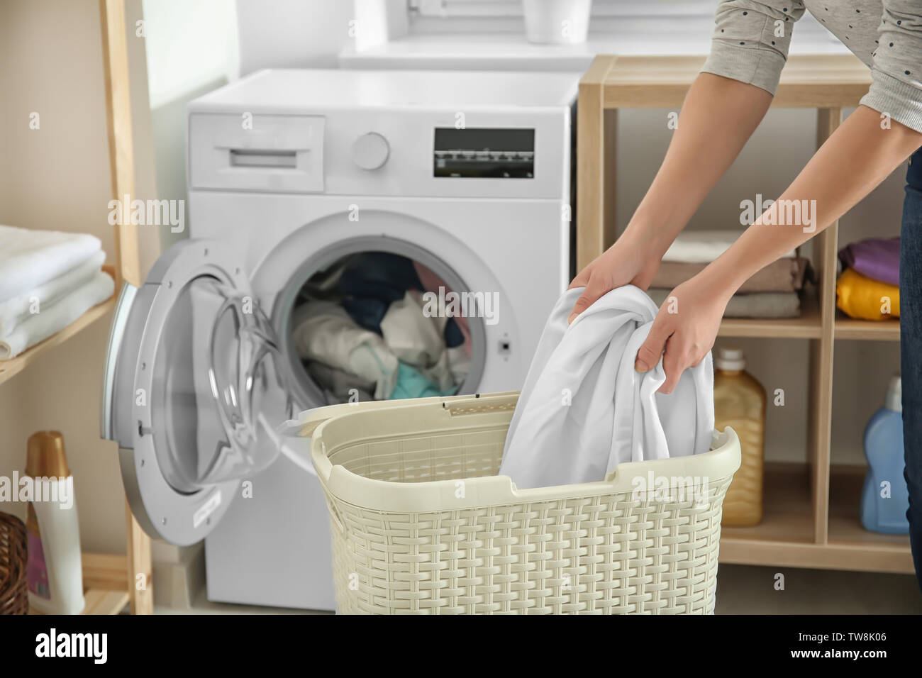 Woman doing laundry at home Stock Photo - Alamy