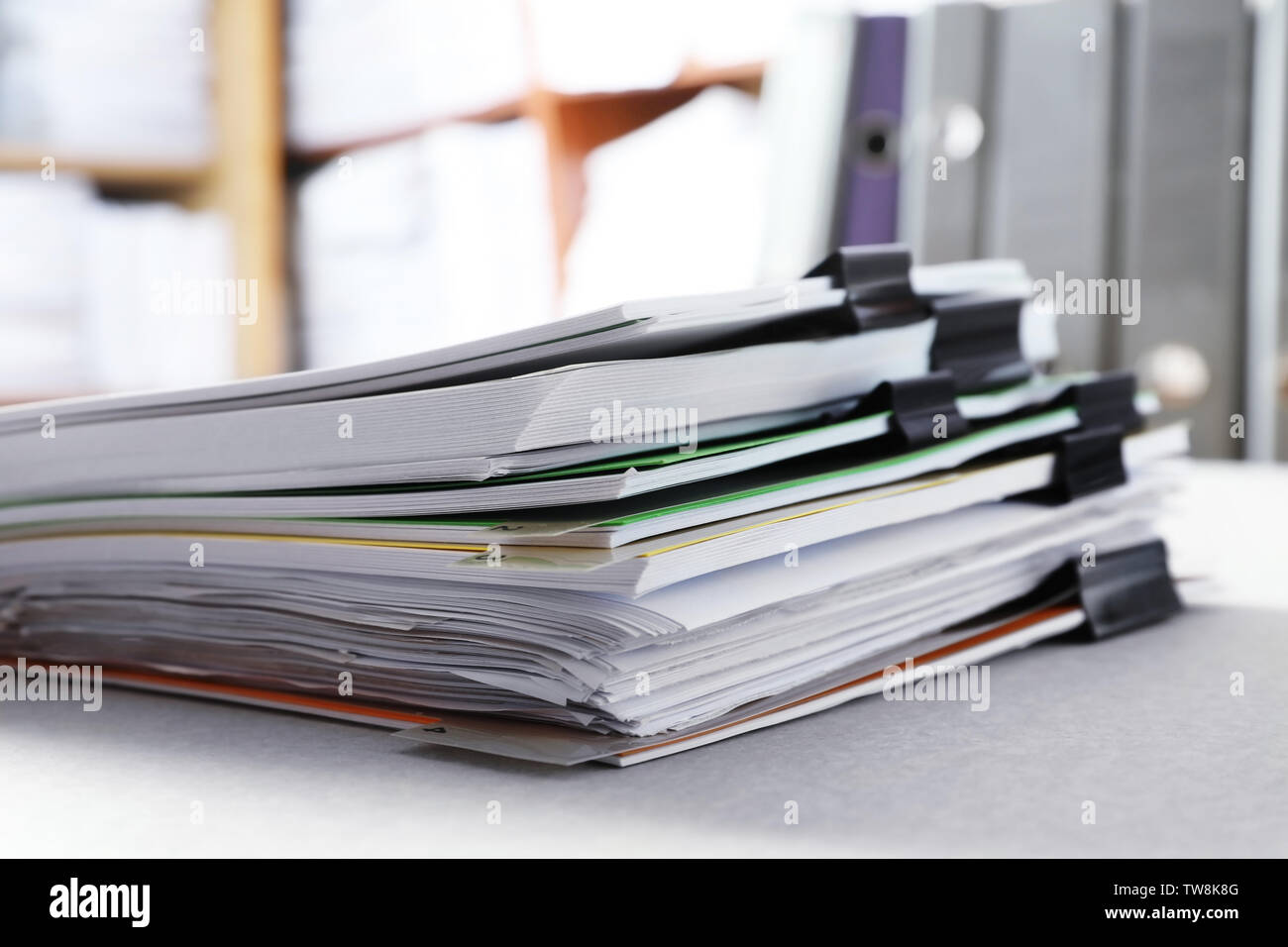 Stack of folders with documents on table in archive Stock Photo - Alamy