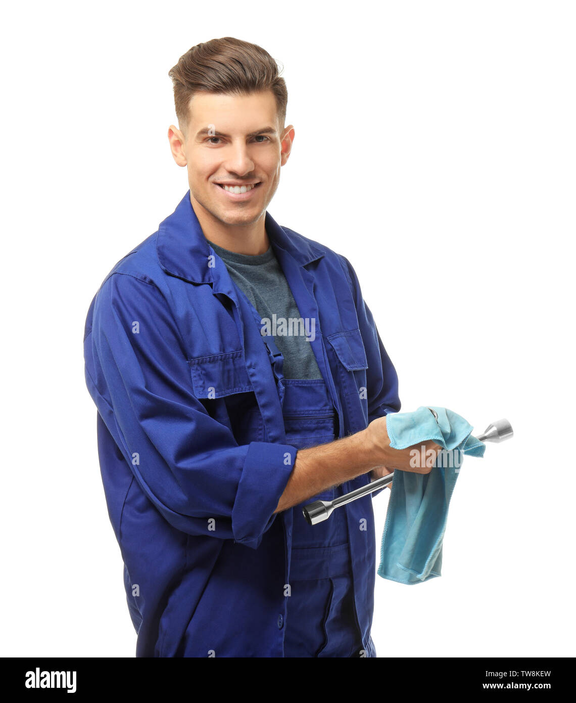Handsome auto mechanic wiping tool on white background Stock Photo - Alamy
