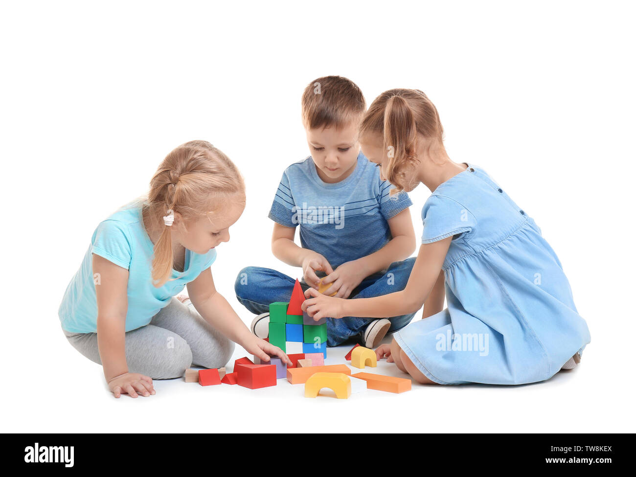 Cute little children playing with building blocks on white background ...
