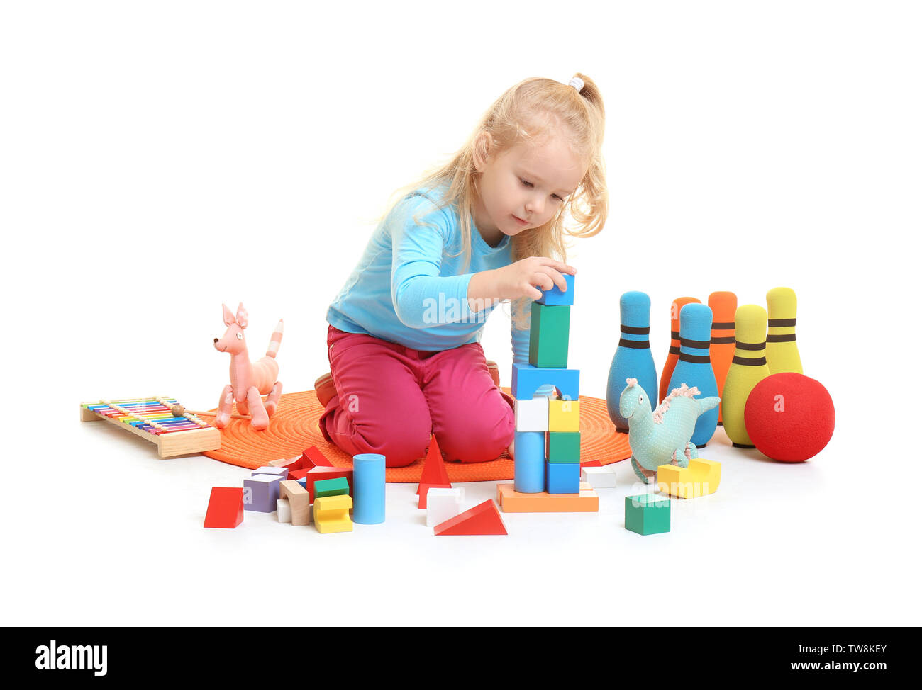 Cute little girl playing with building blocks on white background Stock ...