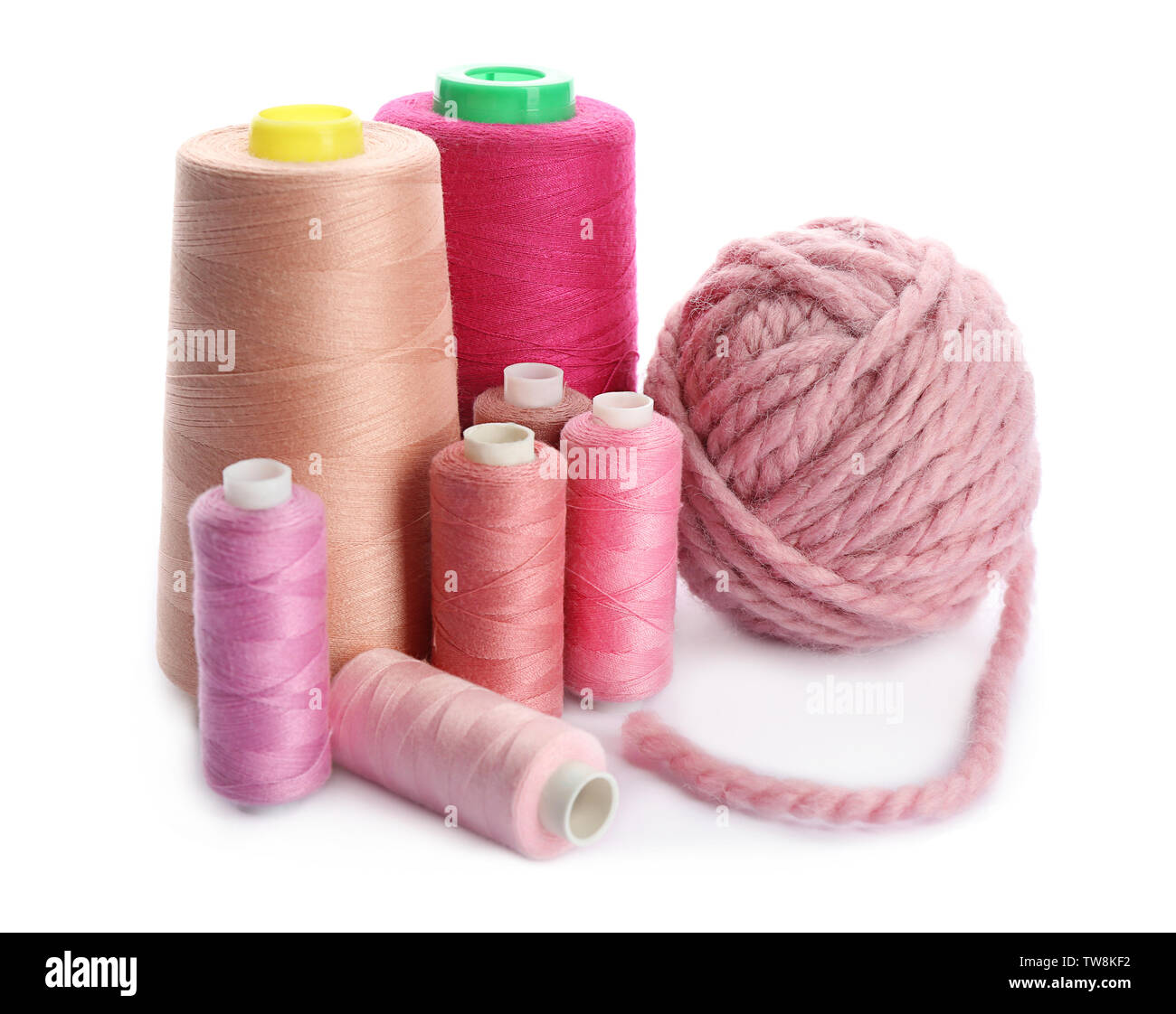 Pink threads of different shades on white background Stock Photo - Alamy