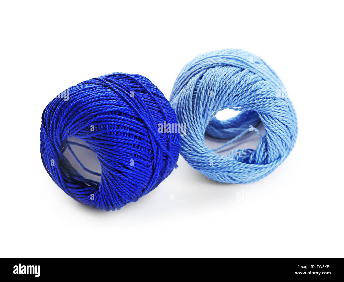 Blue threads of different shades on white background Stock Photo - Alamy