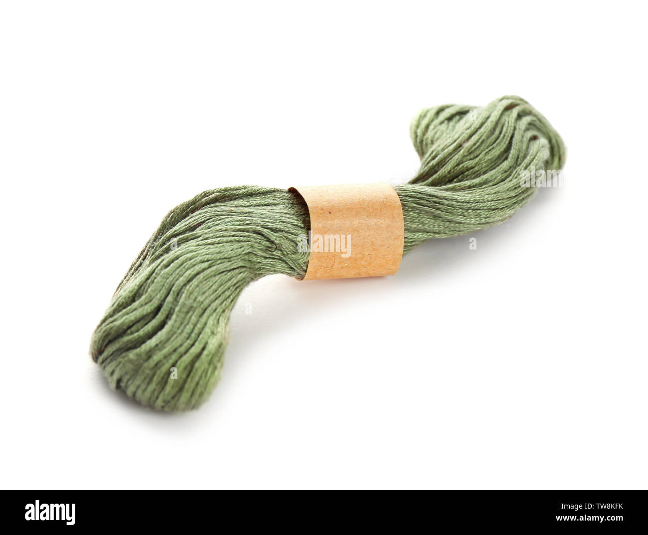 Green embroidery thread on white background Stock Photo - Alamy