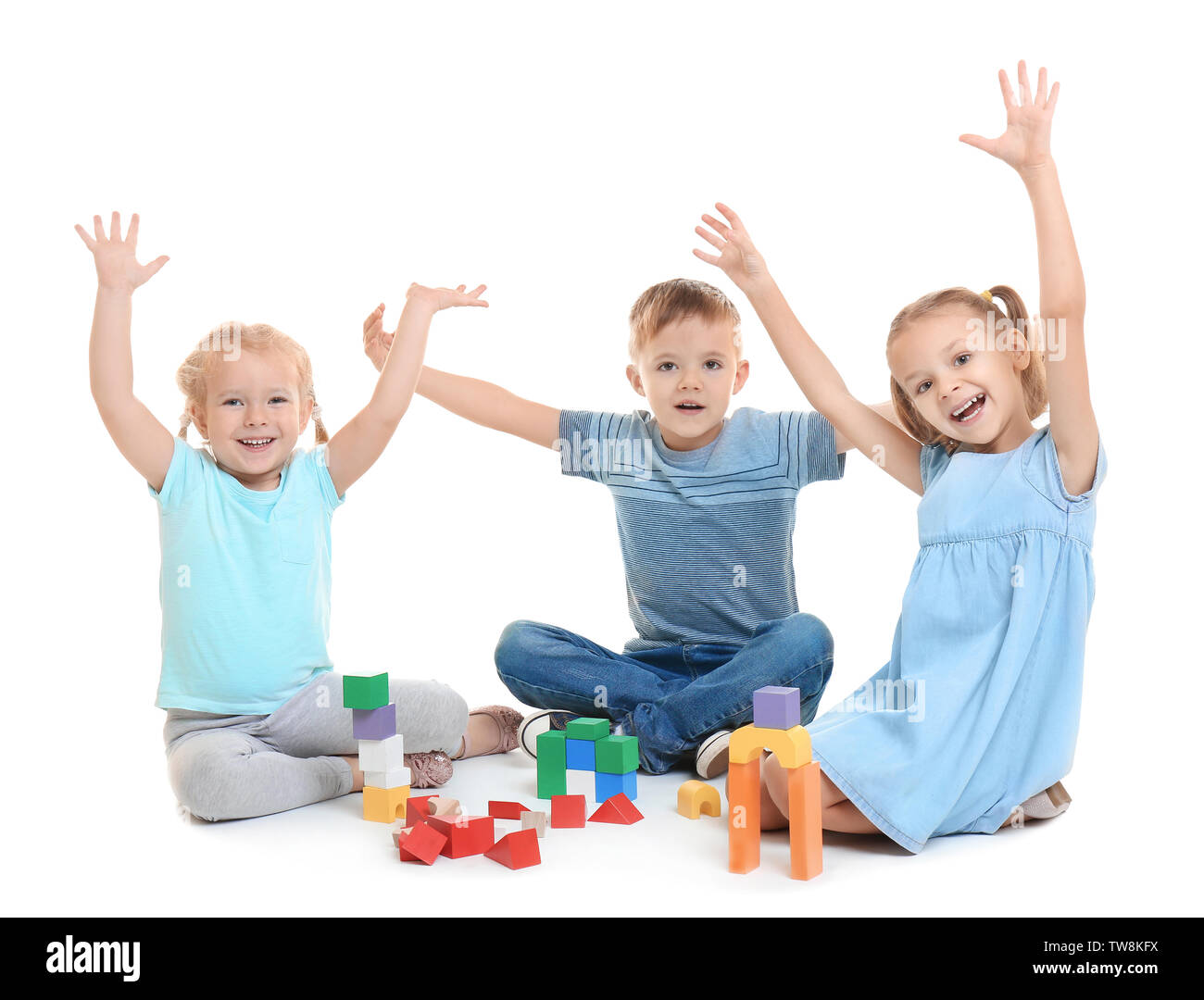 Cute little children playing with building blocks on white background ...