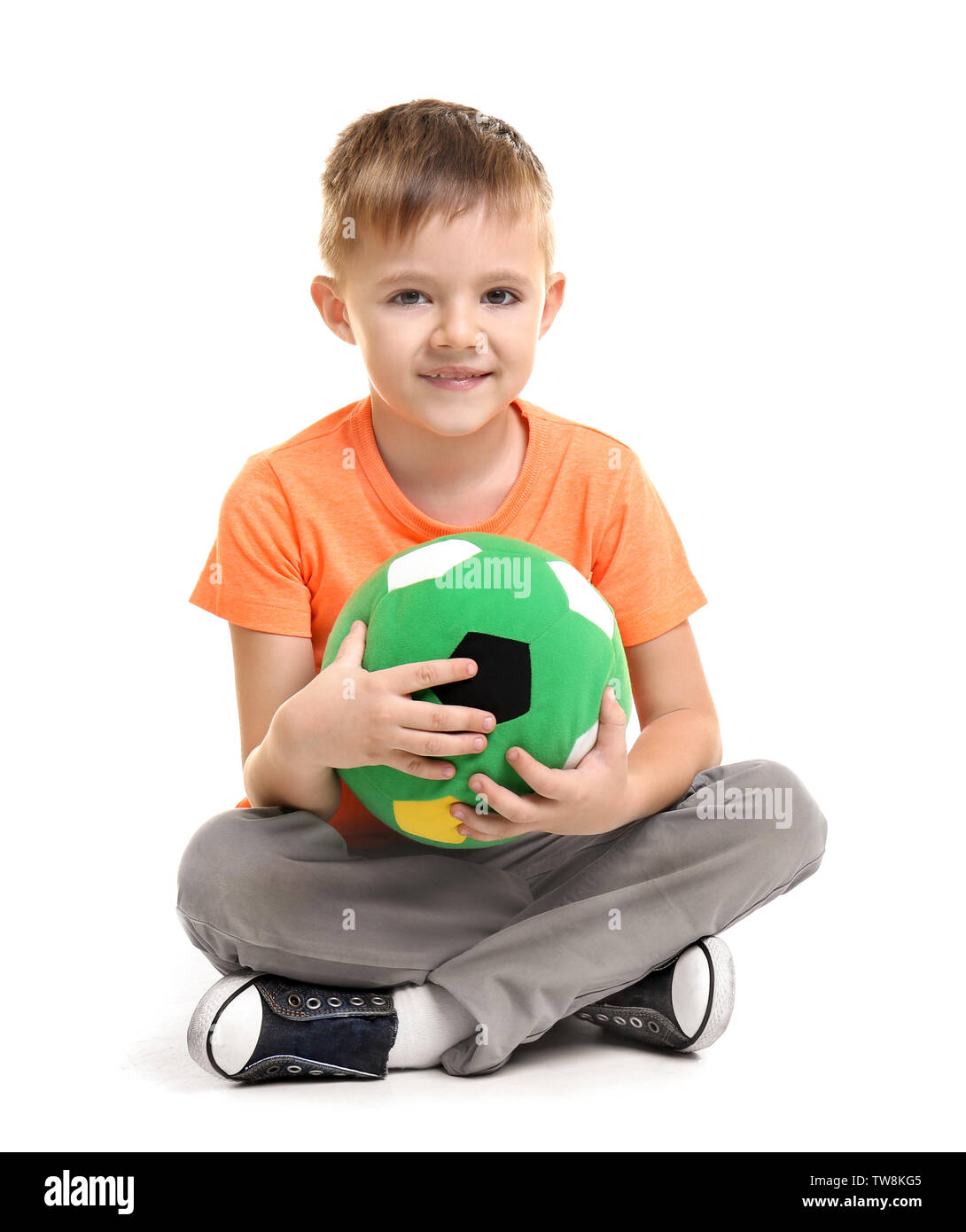 Cute little boy holding ball on white background Stock Photo - Alamy