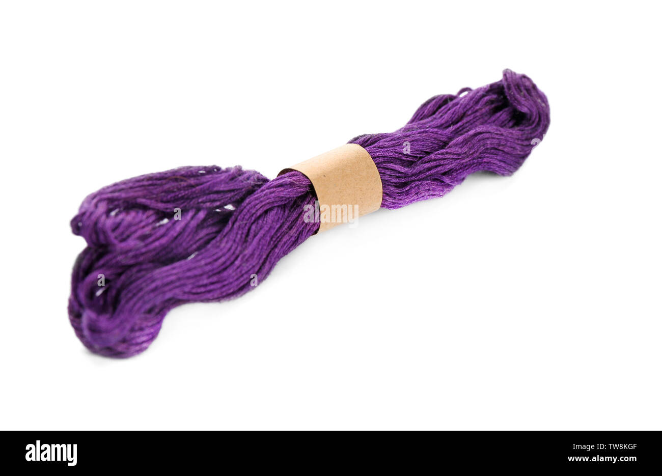 Purple embroidery thread on white background Stock Photo - Alamy