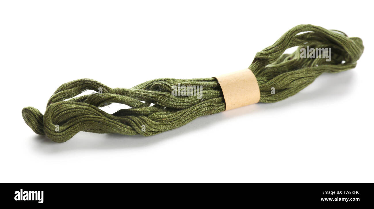 Green embroidery thread on white background Stock Photo - Alamy