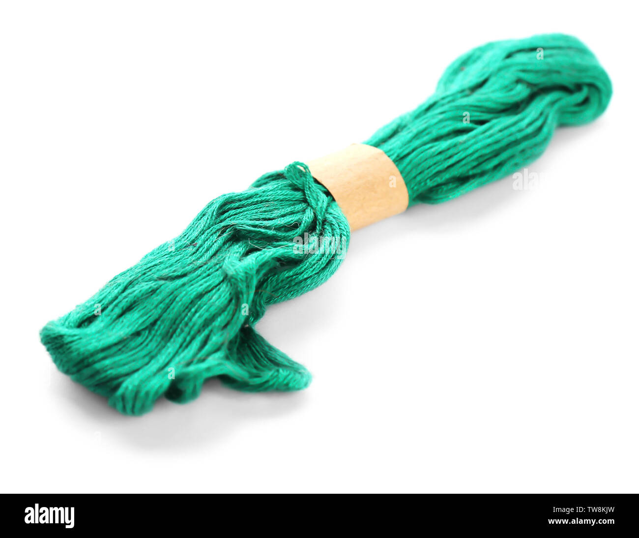 Turquoise embroidery thread on white background Stock Photo - Alamy