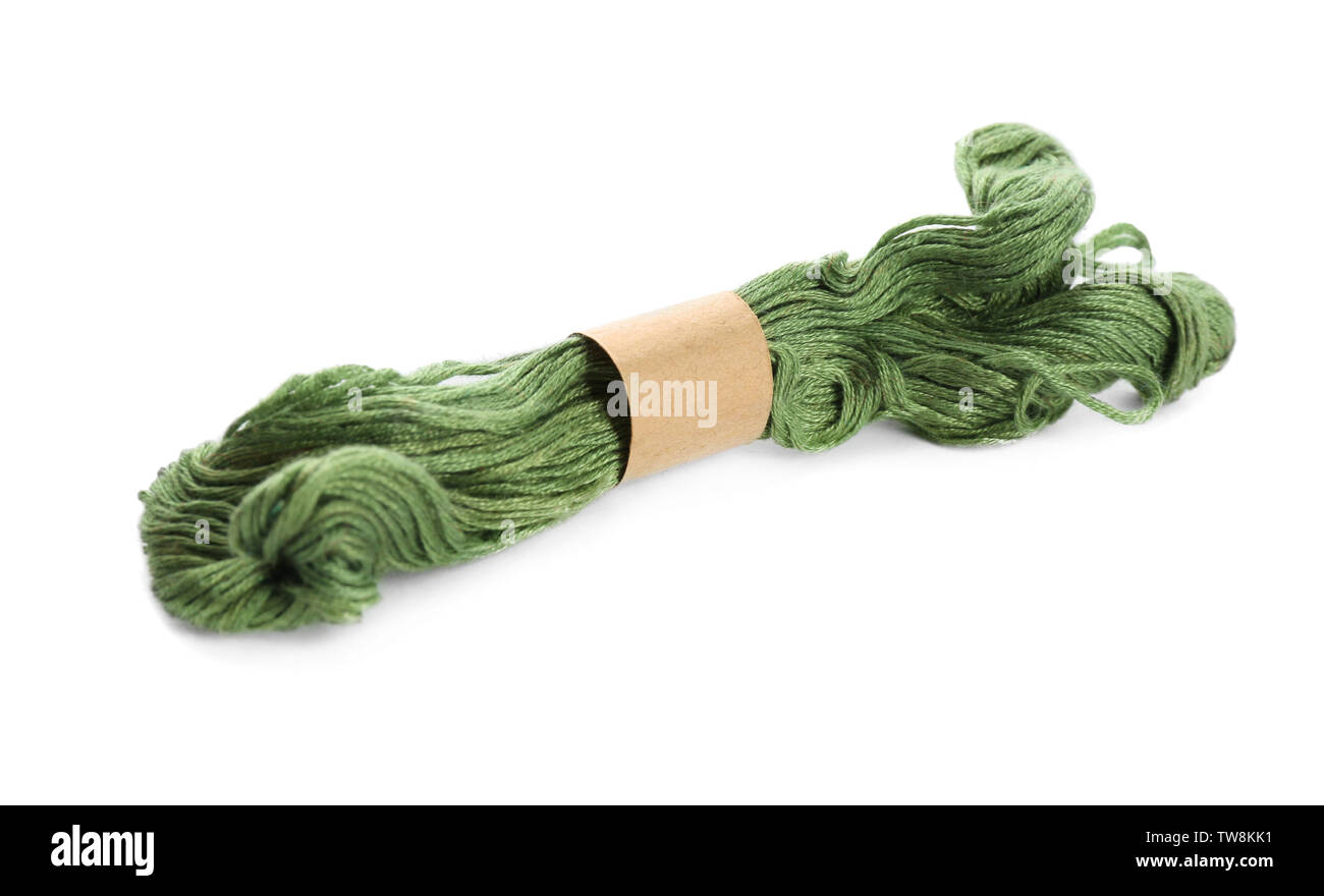 Green embroidery thread on white background Stock Photo - Alamy